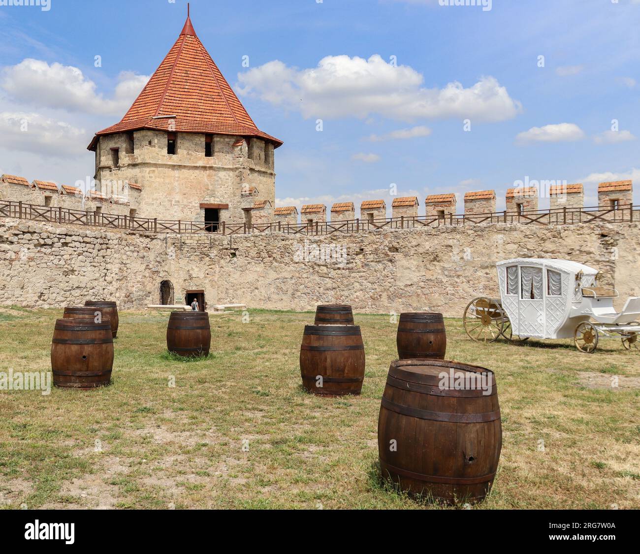 Inside the courtyard of a medieval castle with barrels and a beautiful ...