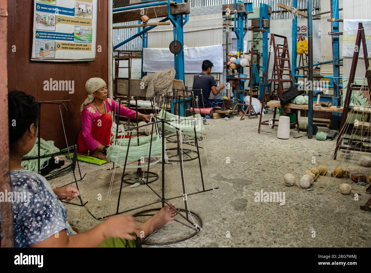 Yarn spinners and weavers at a carpet factory in Jorpati, Kathmandu ...