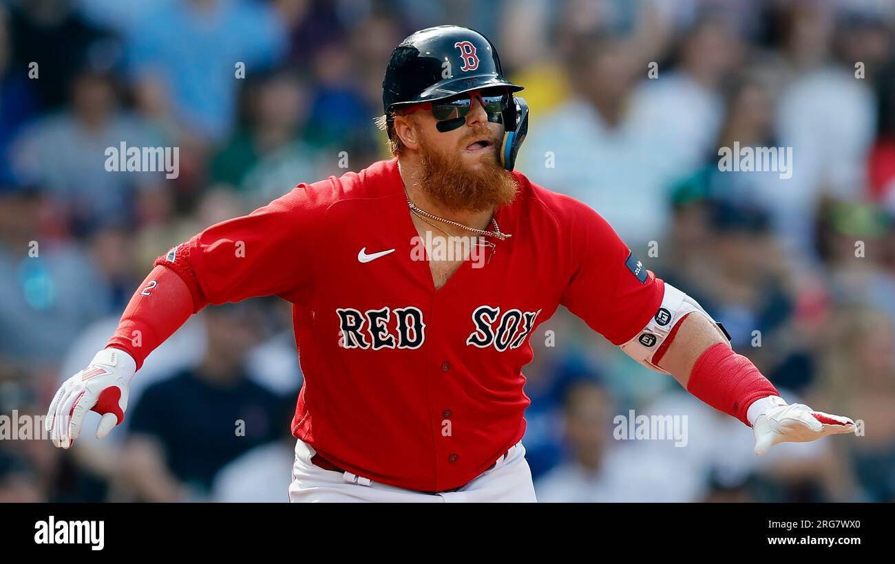 Boston Red Sox's Justin Turner runs on his line out during the first ...