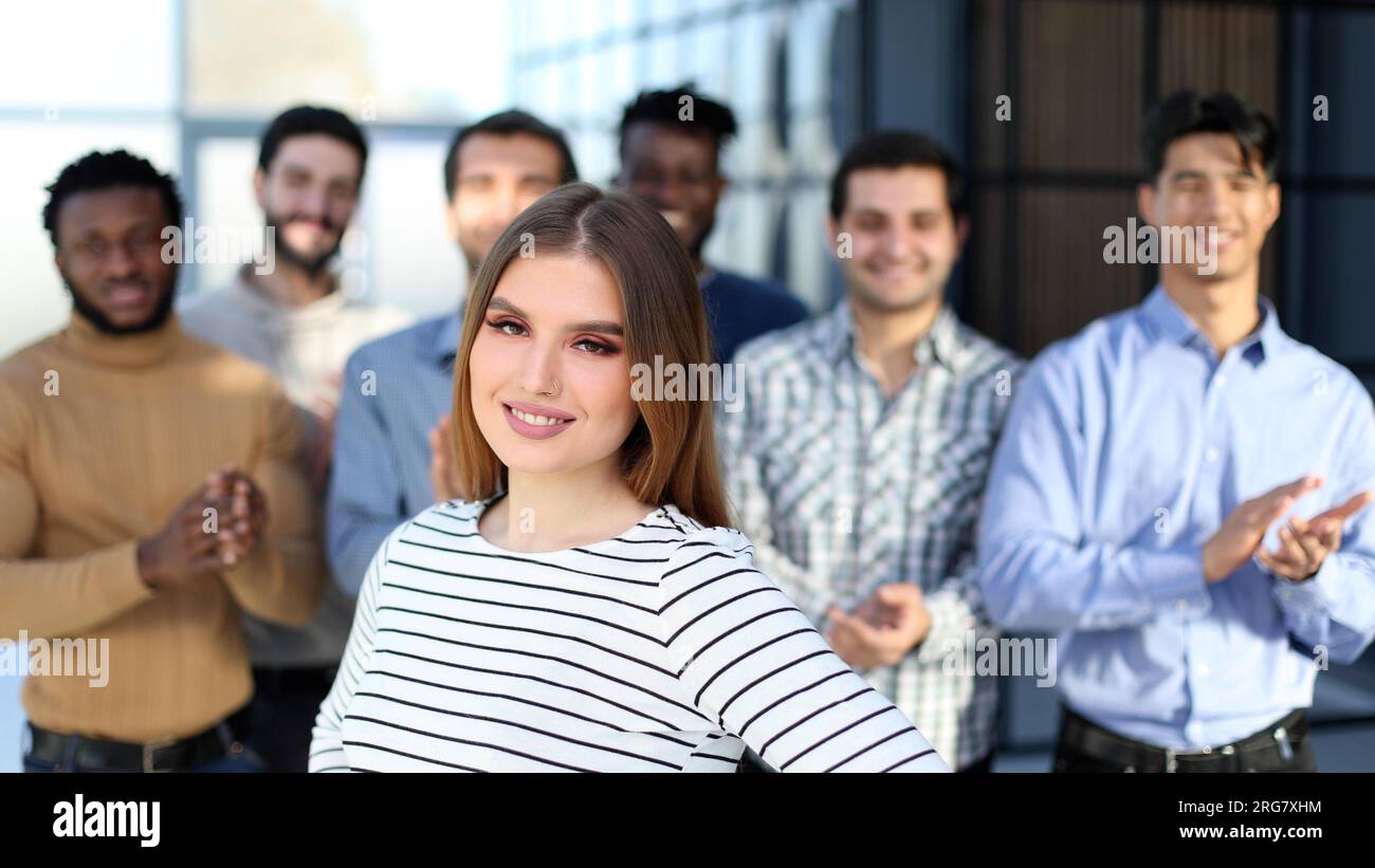 team clapping to the leader woman in the foreground Stock Photo - Alamy