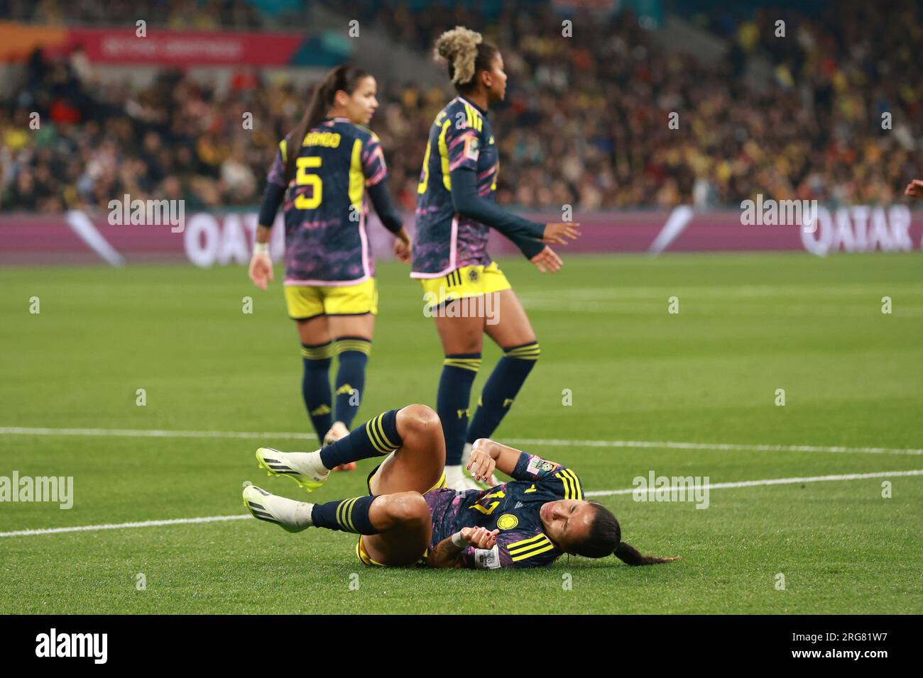 Colombia's Carolina Arias, on the pitch, grimaces in pain during the ...