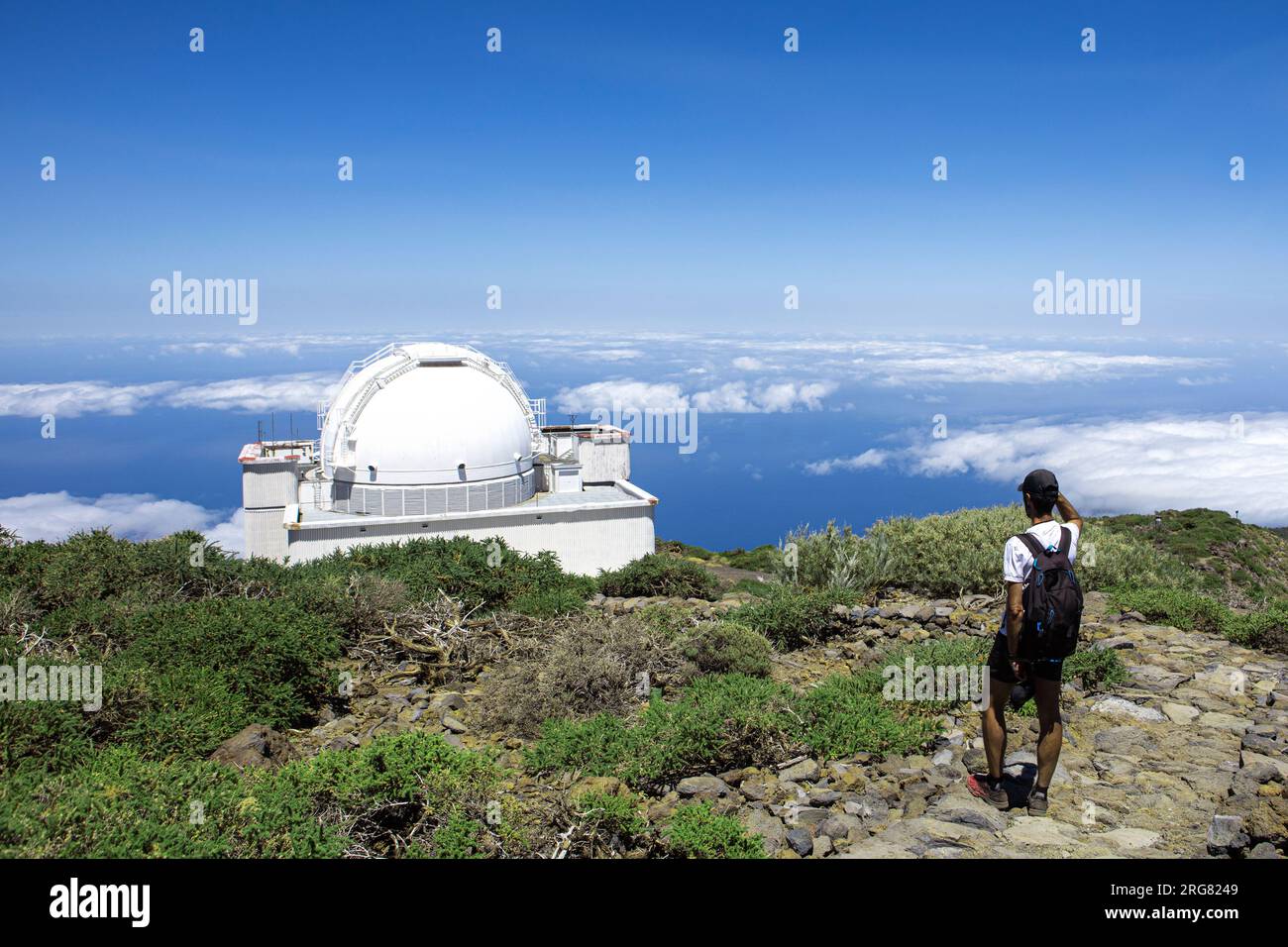 Hiker at the astronomical observatory of Roque de los Muchachos looking at Isaac Newton ...