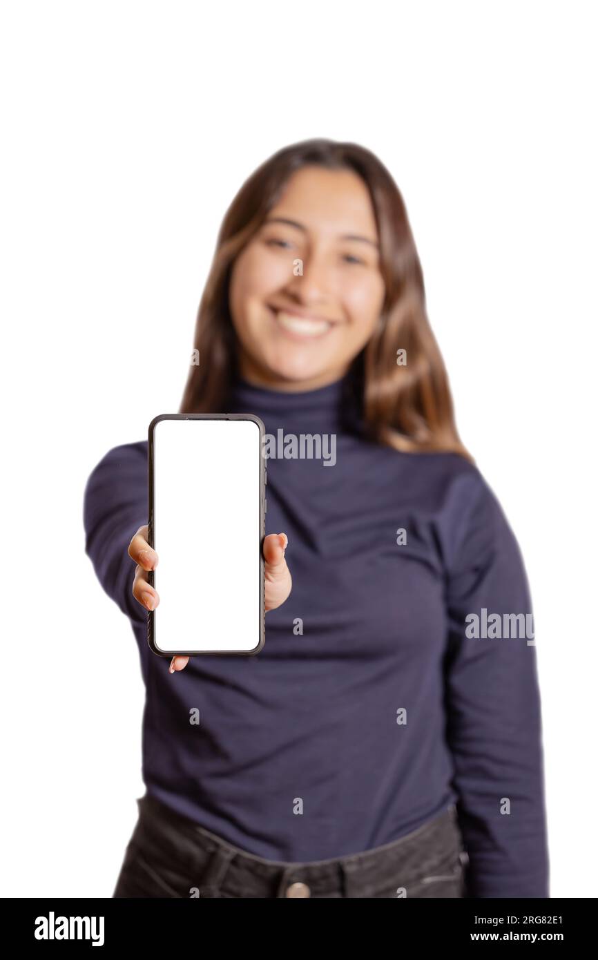 Latin girl out of focus shows the blank screen of her mobile phone ...