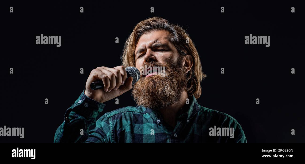 Bearded man singing with microphone. Male singing with a microphones ...