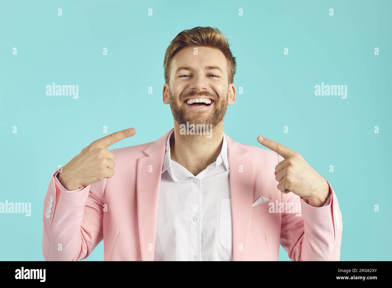 Happy young man pointing at his perfect smile and showing his white ...