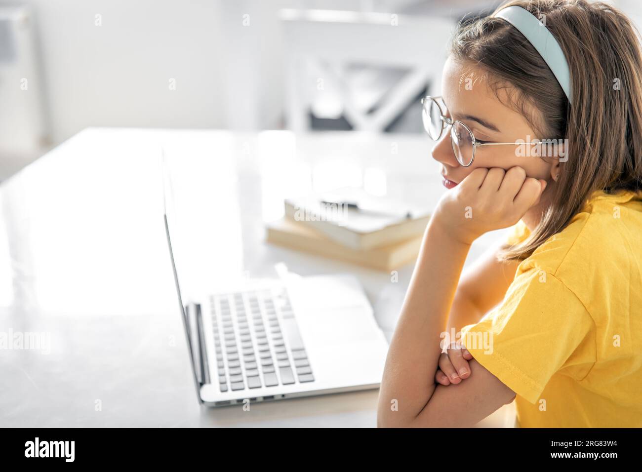 Exhausted schooler girl suffering from doing homework, tired from ...