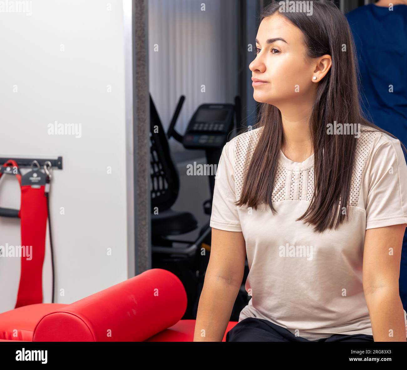 Female patient at a fitness center, undergoing rehabilitation ...