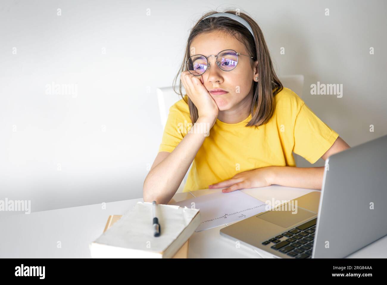 Exhausted schooler girl suffering from doing homework, tired from ...