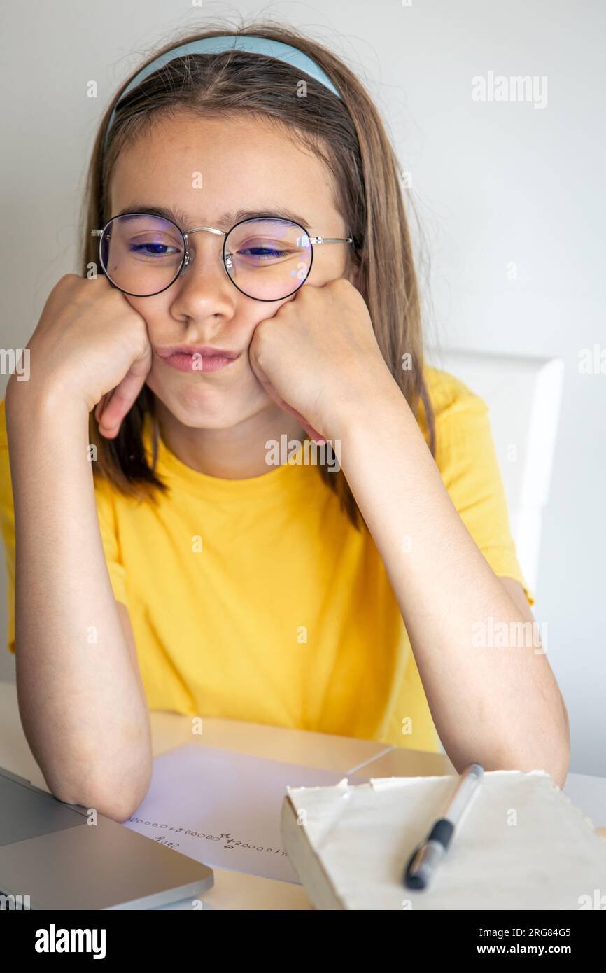 Exhausted schooler girl suffering from doing homework, tired from ...