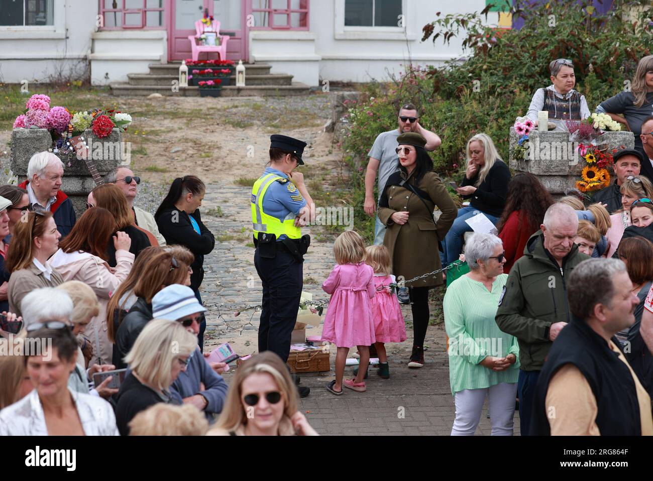 A Garda officer talking to people outside the former home of the late ...