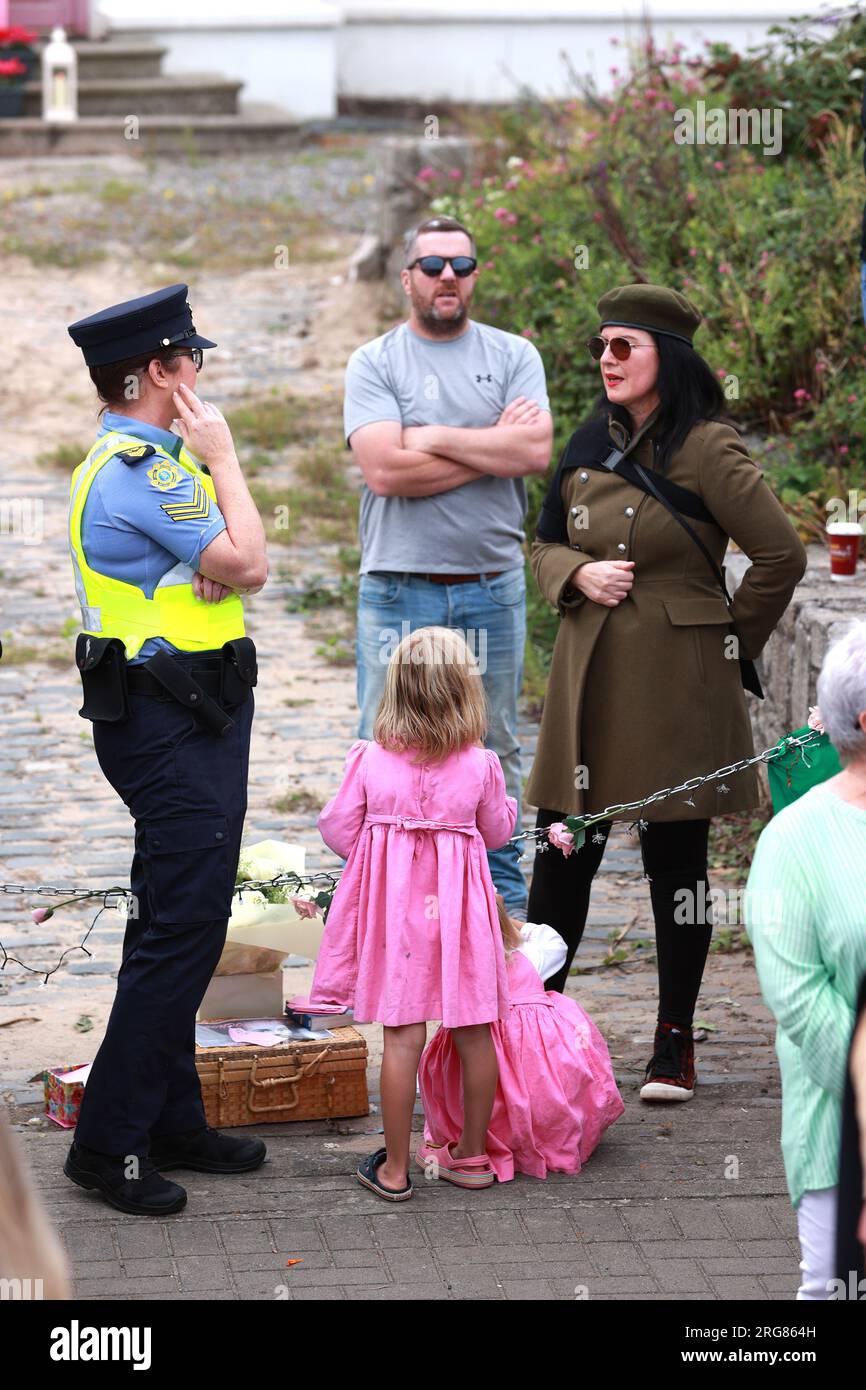A Garda officer talking to people outside the former home of the late ...