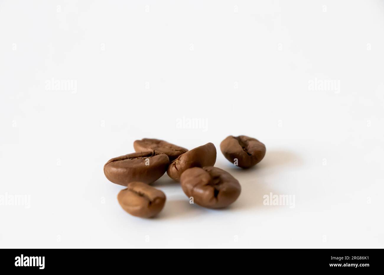 Dark coffee beans. A small group of dark coffee beans on the right ...