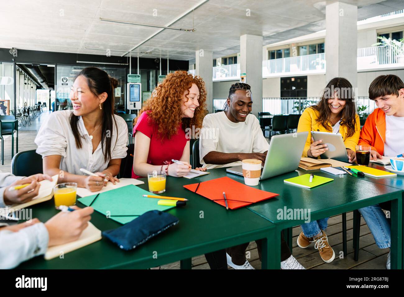 Diverse student group of college people studying together at college ...