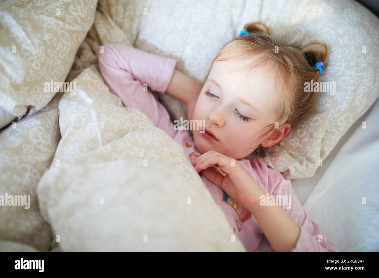 Adorable preschooler girl having a day nap. Little child sleeping in ...