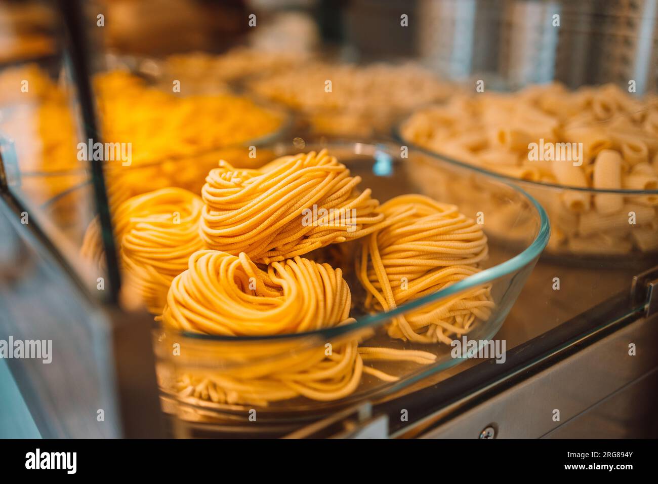 Traditional Italian fresh made colorful organic pasta in shop window ...