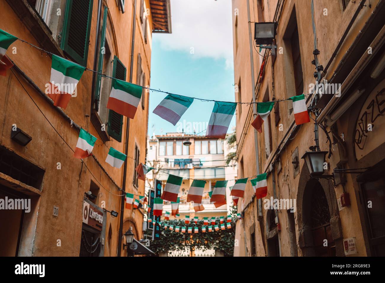 Holiday in the Italian city of streets with Italian flags and ancient ...
