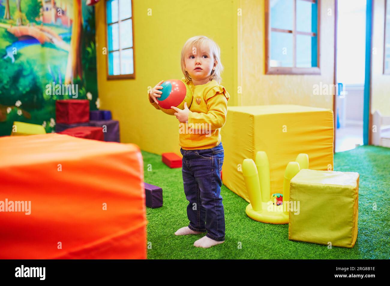 Adorable little girl in kindergarten, daycare or preschool. Toddler ...