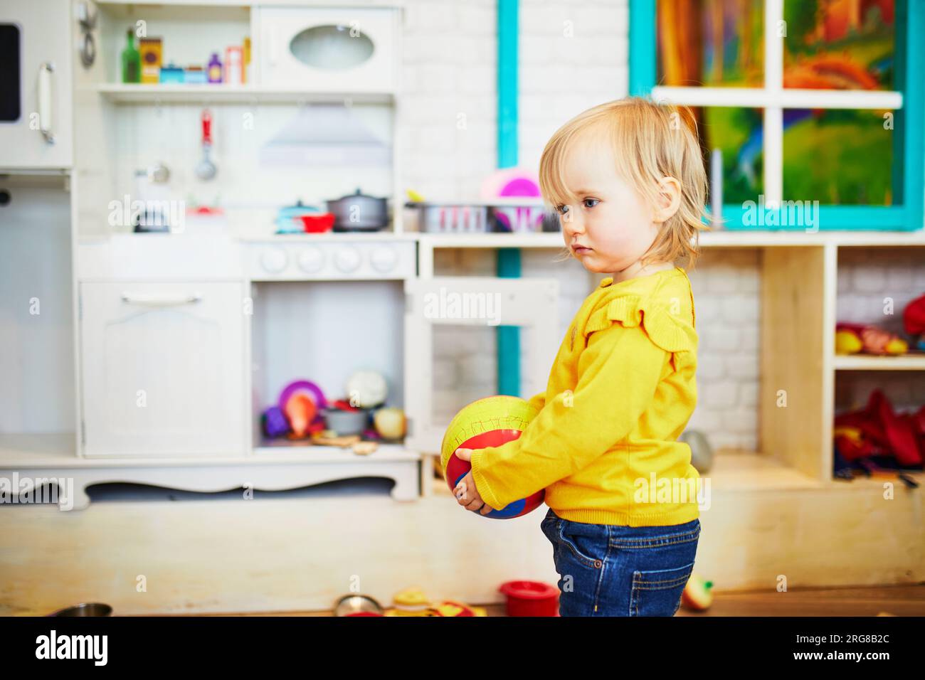 Adorable little girl in kindergarten, daycare or preschool. Toddler ...