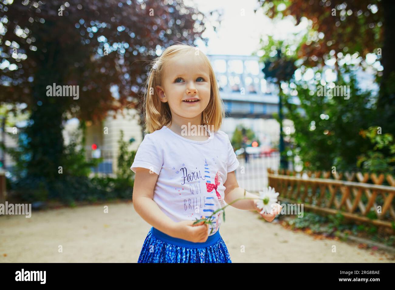 Happy cheerful toddler girl walking in park in Paris, France Stock ...