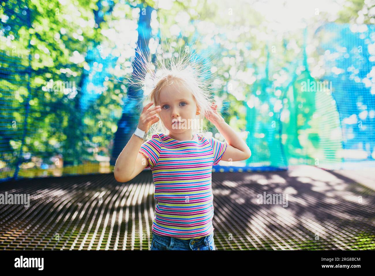Adorable little girl having fun in adventure park. Child with ...