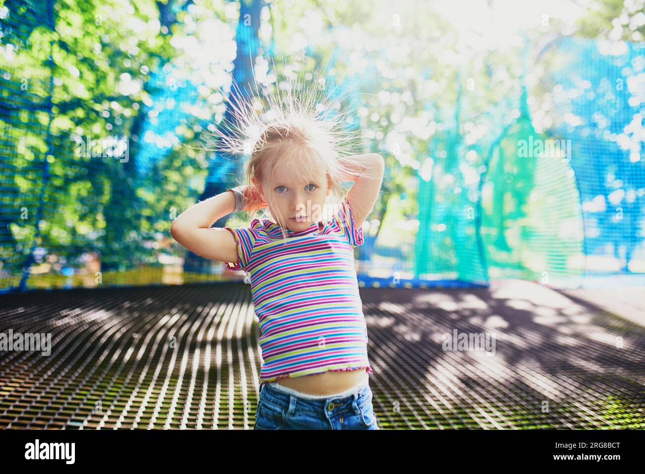 Adorable little girl having fun in adventure park. Child with ...