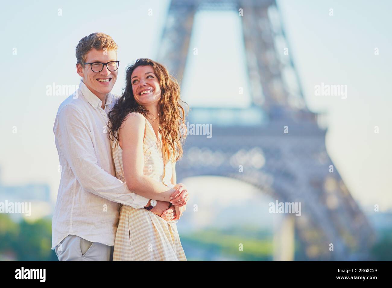 Happy romantic couple in Paris, near the Eiffel tower. Tourists ...
