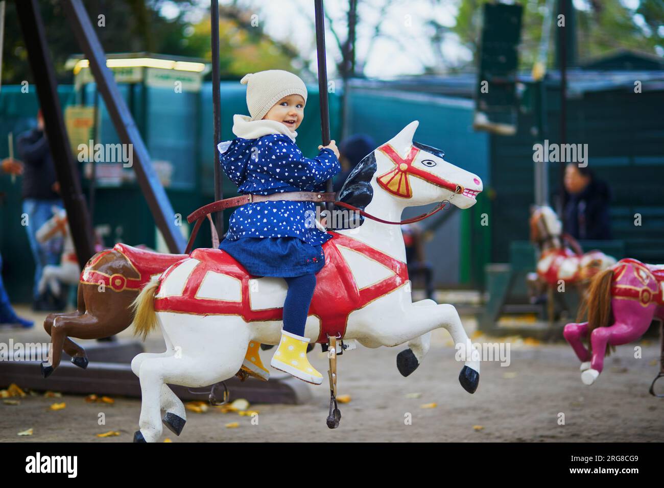 Toddler having fun on vintage French merry-go-round in Paris. Adorable ...