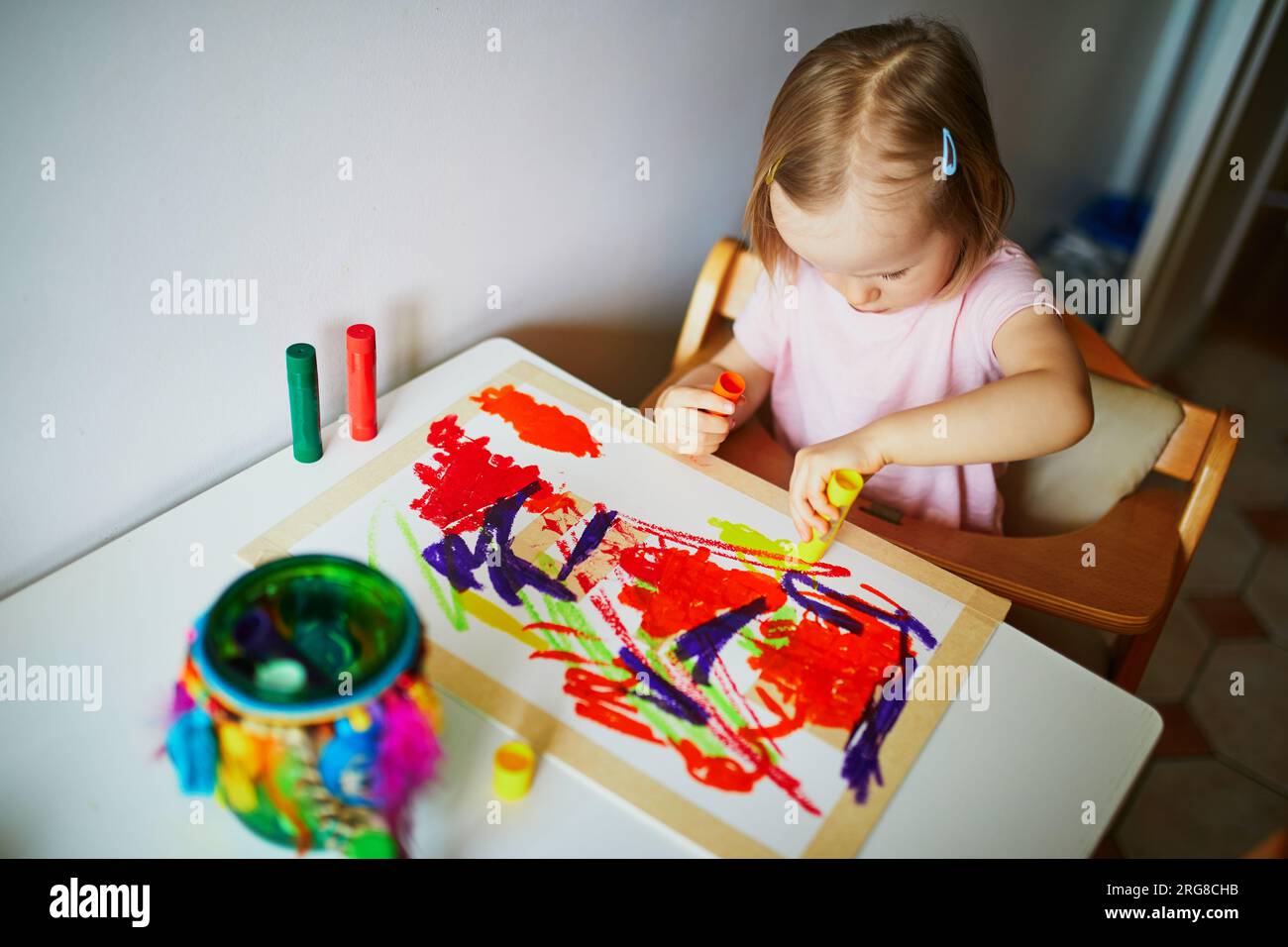 Adorable little girl drawing with colorful paints at home, in ...