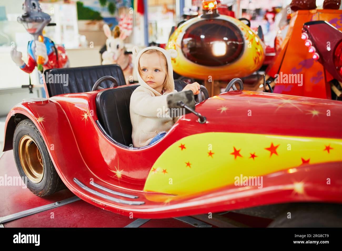 Toddler having fun on vintage French merry-go-round in Paris, France ...