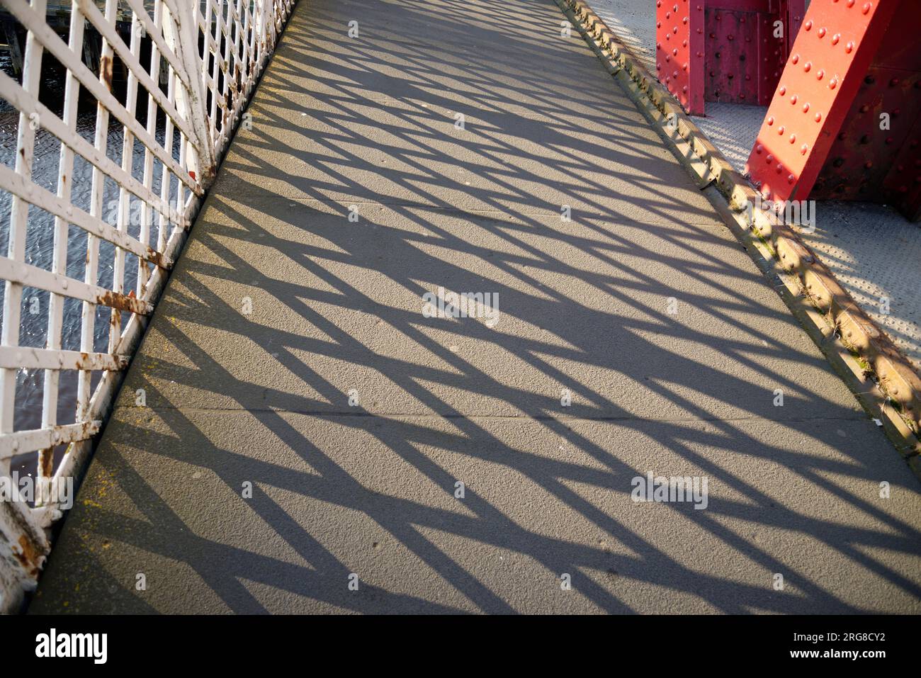 Latticed patterned balustrade with sunlight producing a shadow pattern ...