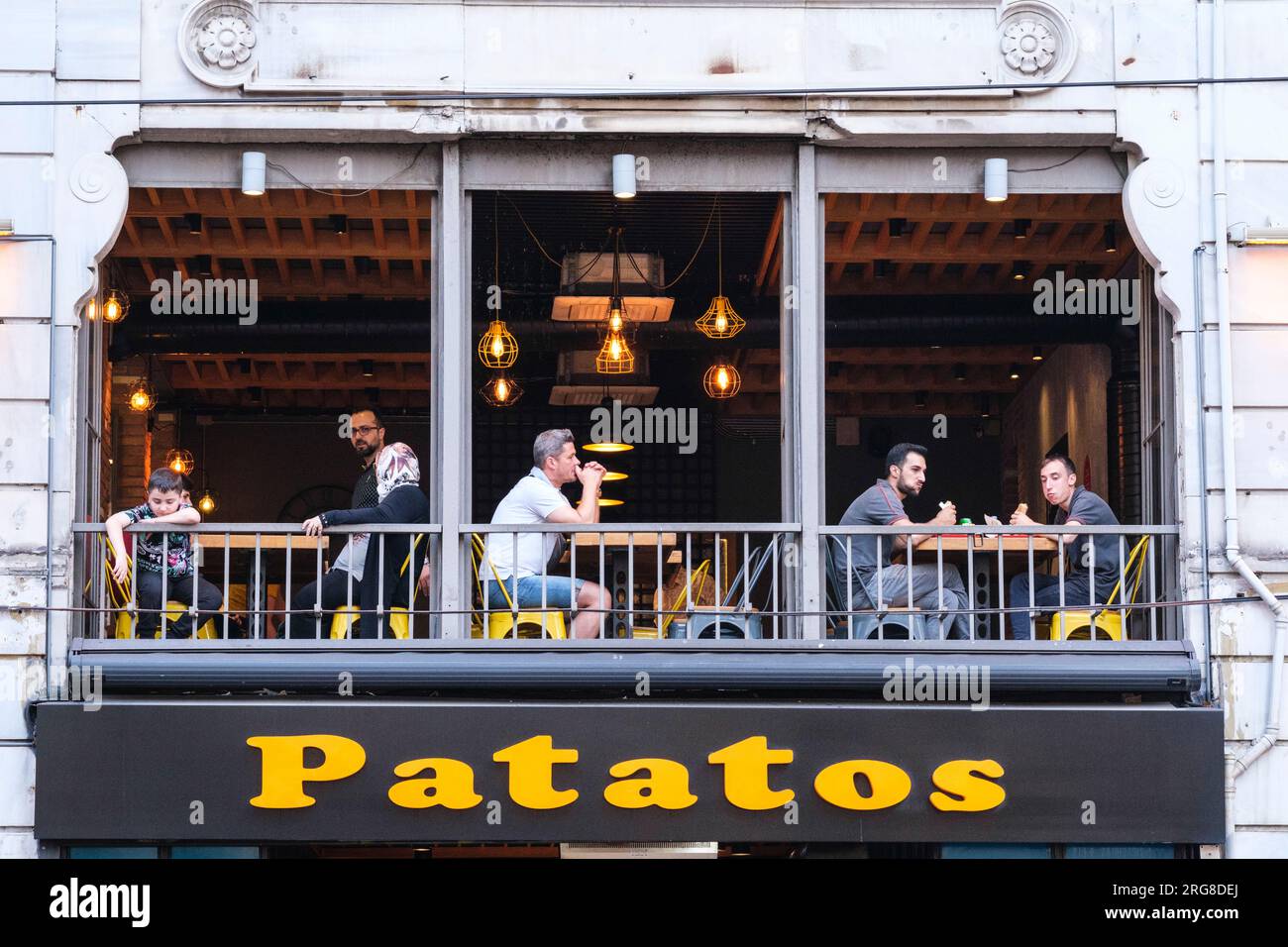 Istanbul, Turkey, Türkiye. Patrons at Patatos Fast Food Restaurant Look ...