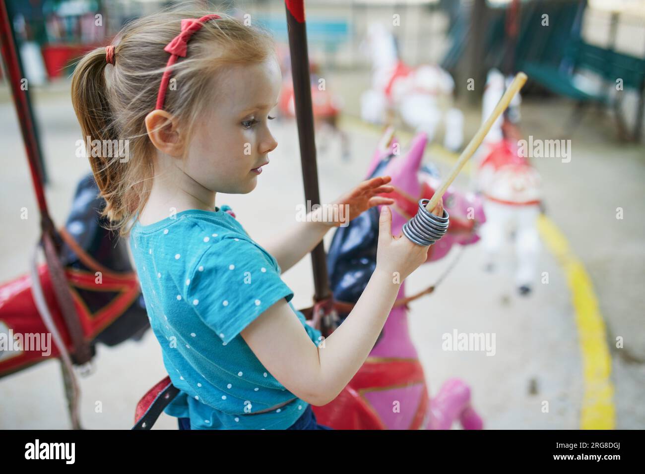 Adorable little girl on the playground. Preschooler girl having fun on ...