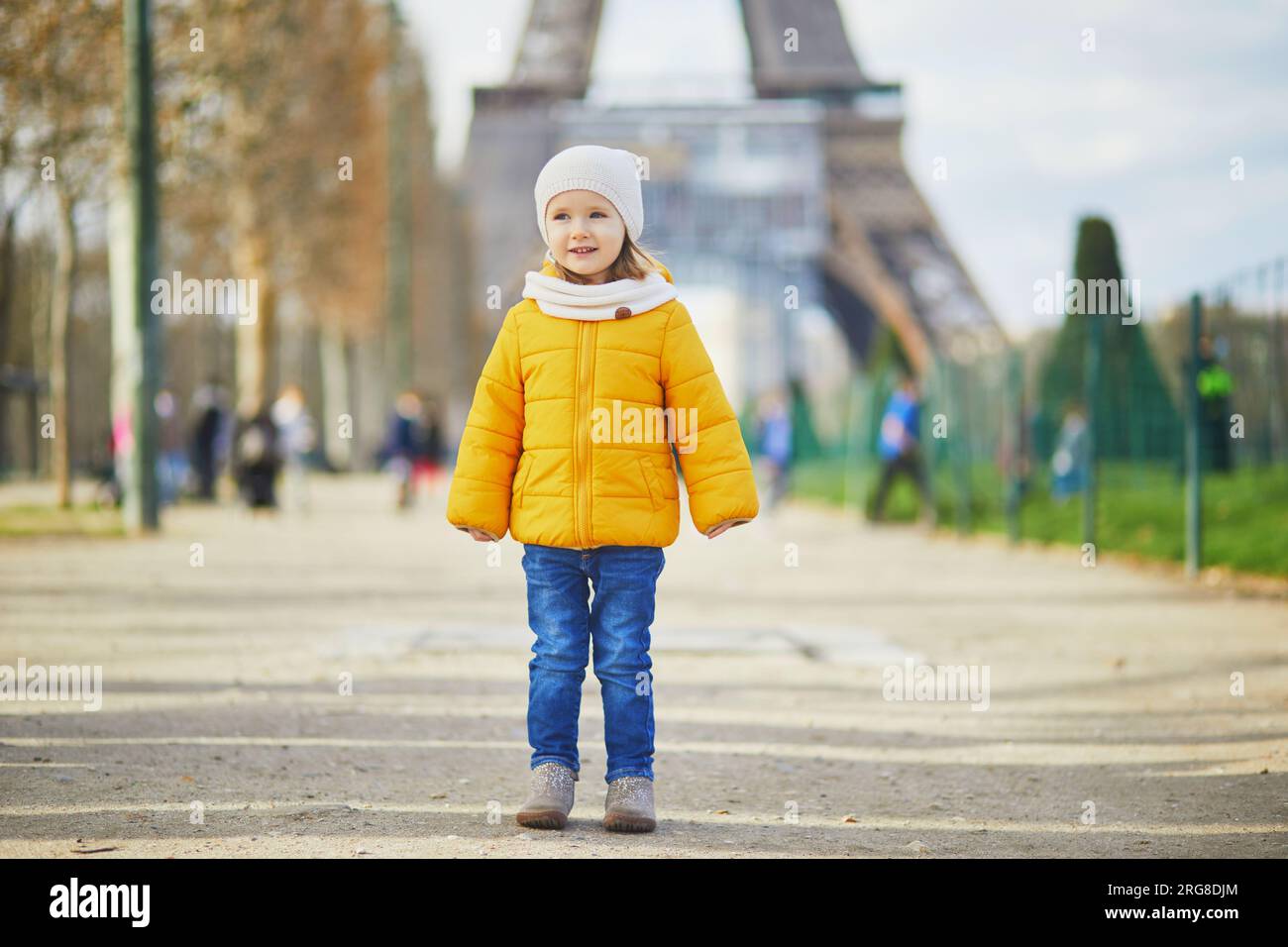 Adorable toddler girl walking near the Eiffel tower in Paris, France ...