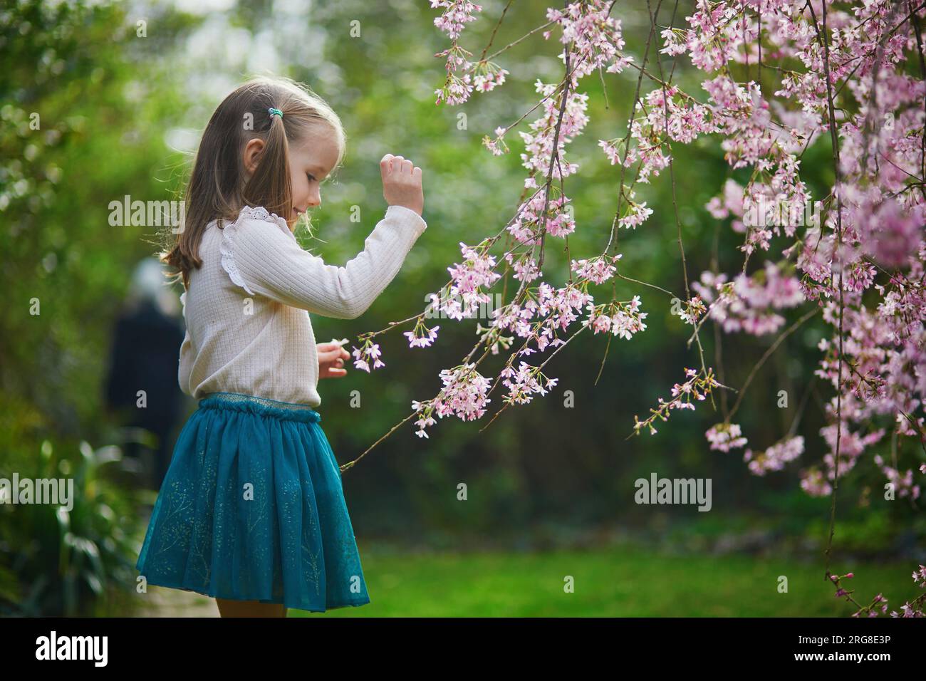 Adorable preschooler girl enjoying nice spring day in park during ...