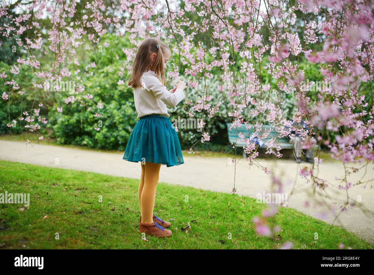 Adorable preschooler girl enjoying nice spring day in park during ...