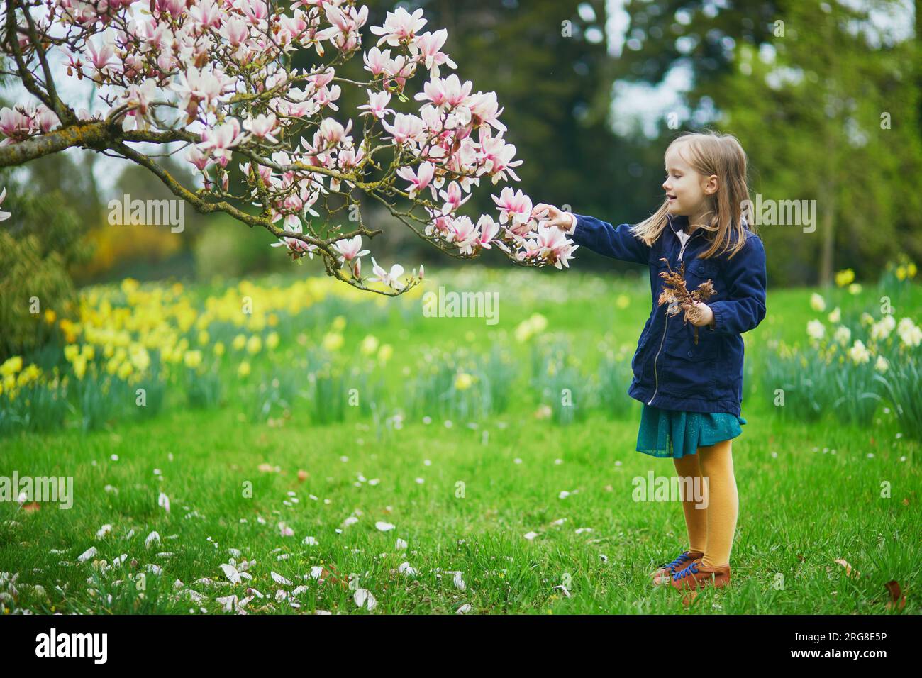 Adorable preschooler girl enjoying nice spring day in park during ...
