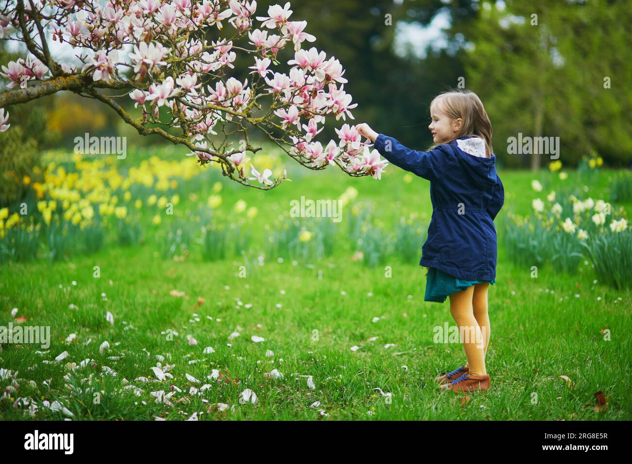 Adorable preschooler girl enjoying nice spring day in park during ...