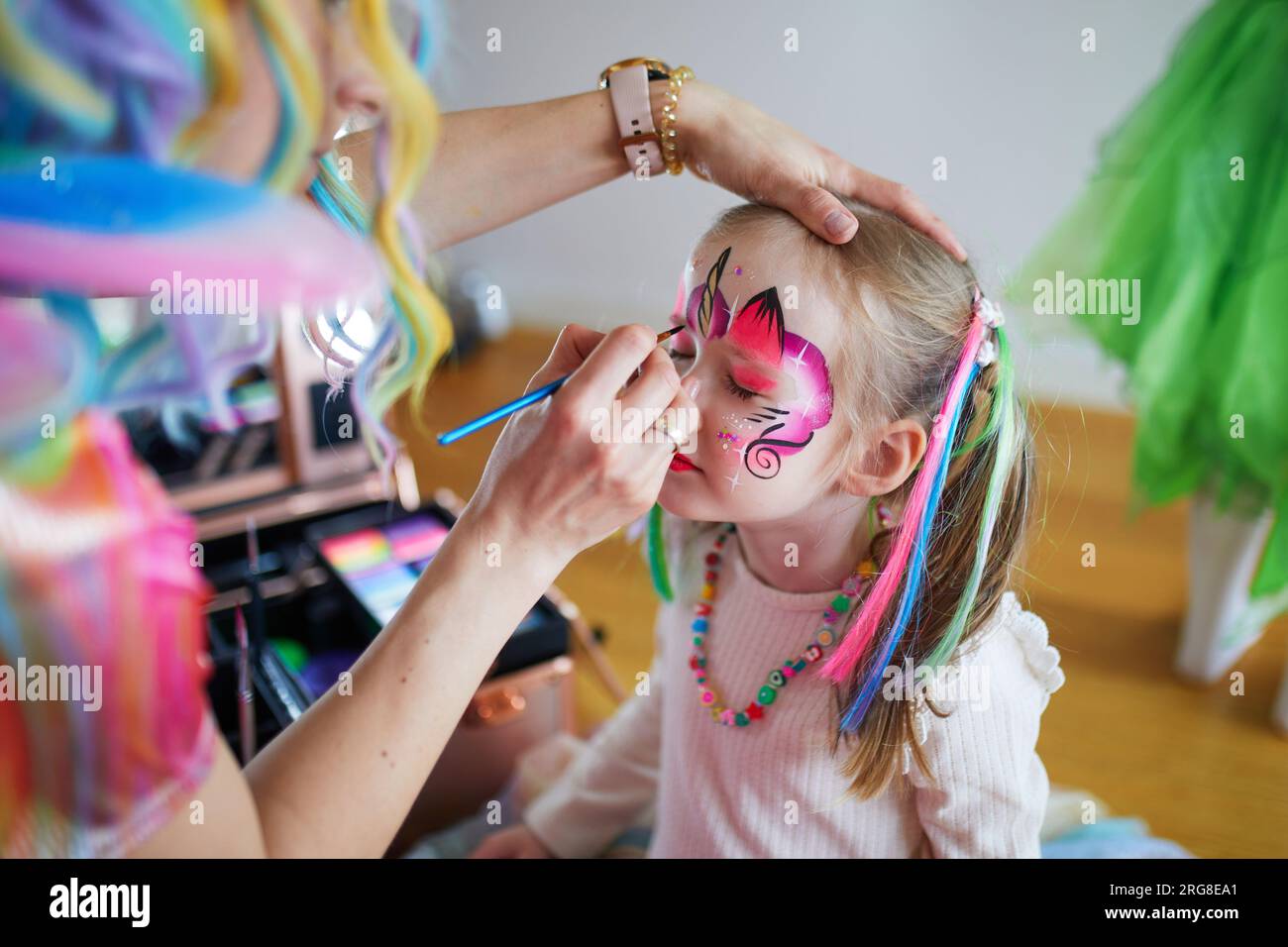Children face painting. Artist painting little preschooler girl like ...