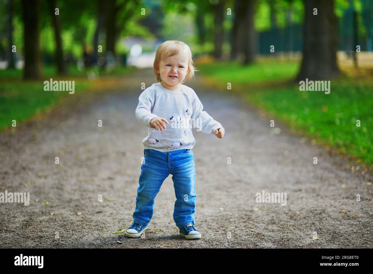 Little girl crying in a park. Unhappy and emotional small kid. Toddler ...