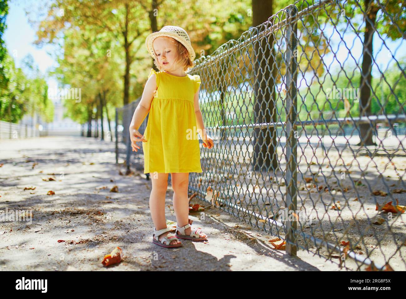 Unhappy and emotional toddler girl in park. Misbehaving child outdoors ...