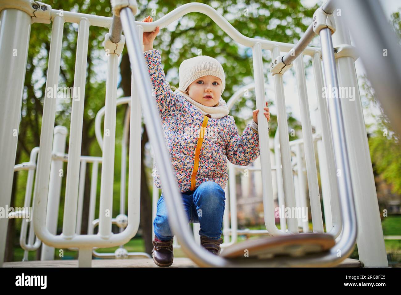 Happy 3 years old girl playing on a playground in Paris, France ...