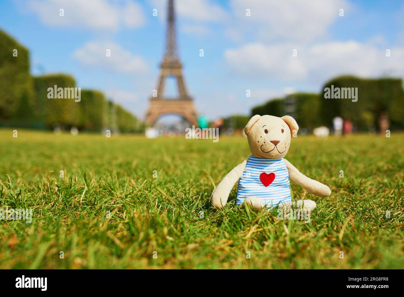 Teddy bear sitting on the grass near the Eiffel tower in Paris France ...