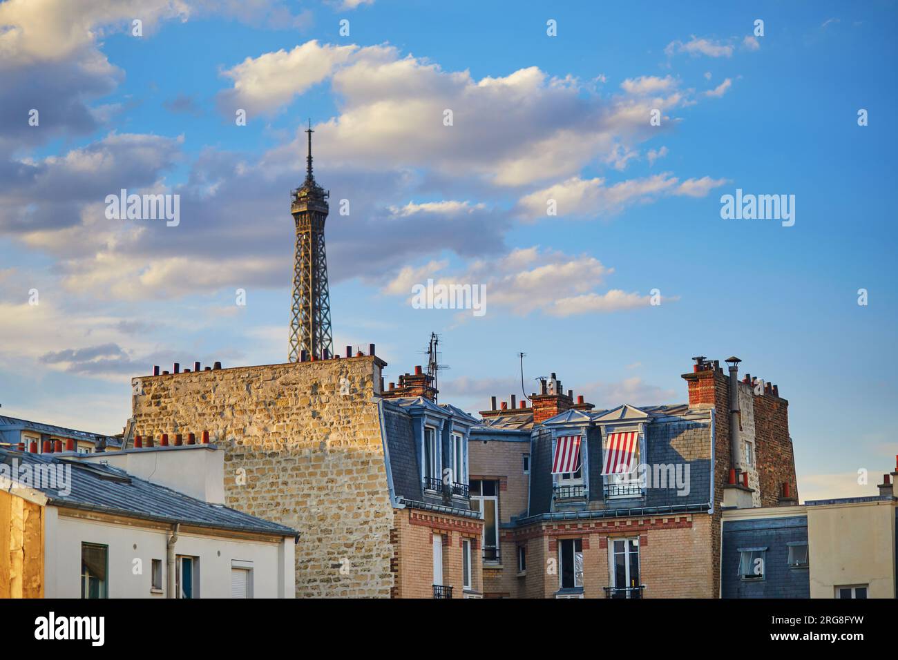 View of the Eiffel tower over the roofs of residential buildings in ...