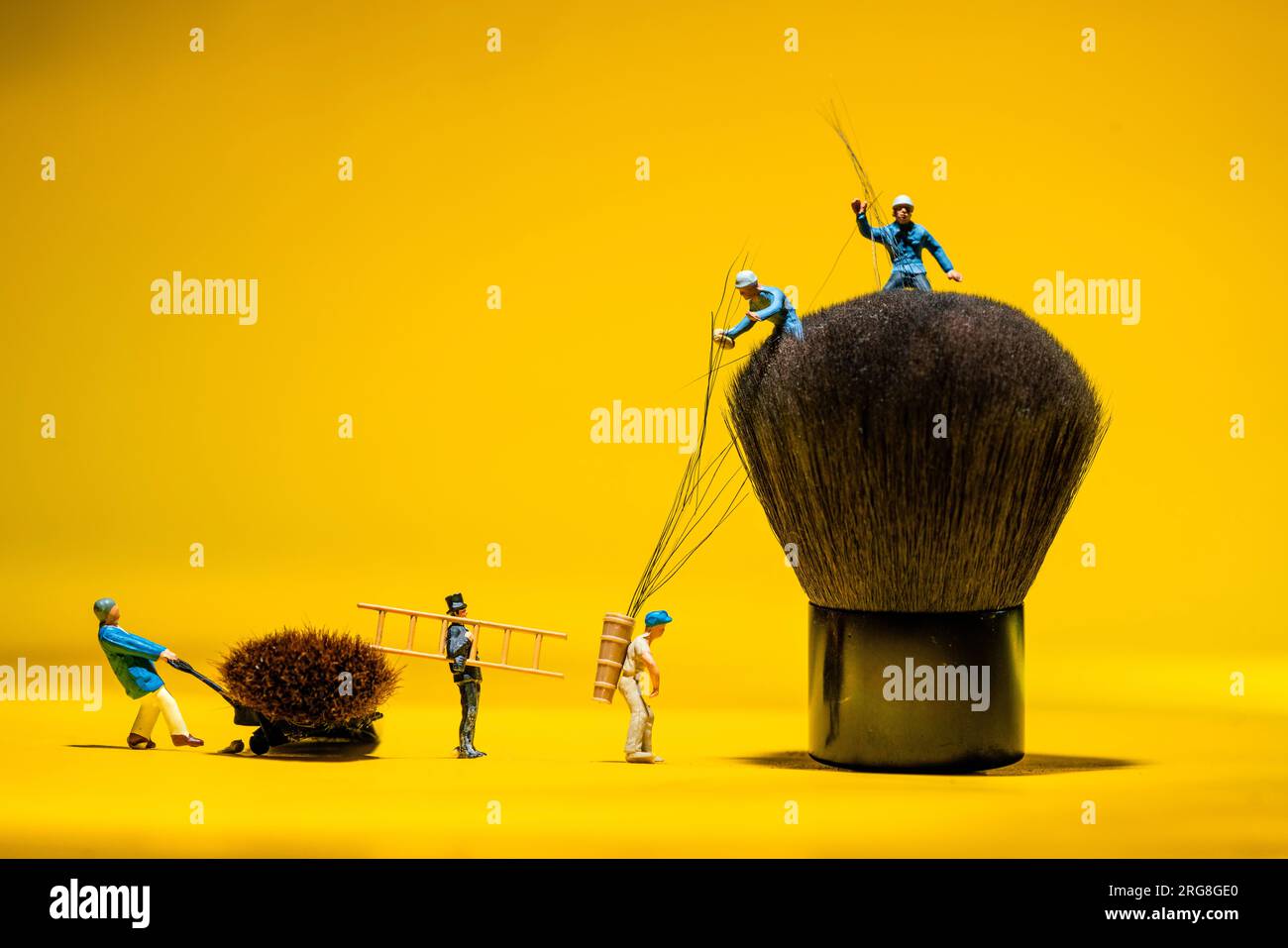 Miniature workers are adding fresh bristles to a shaving brush Stock ...