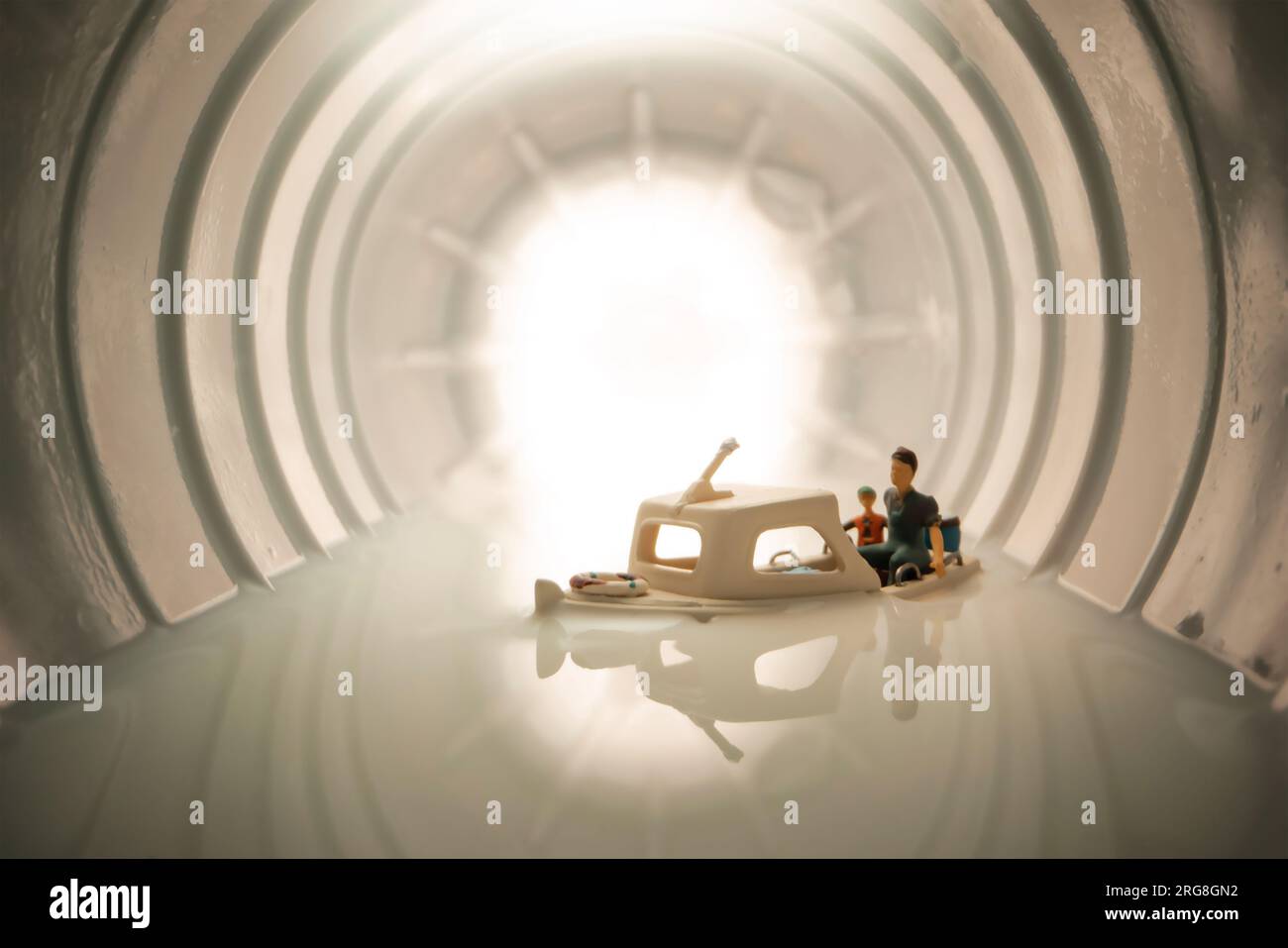 The Milky Way Miniature father and son in a small motorboat inside a ...
