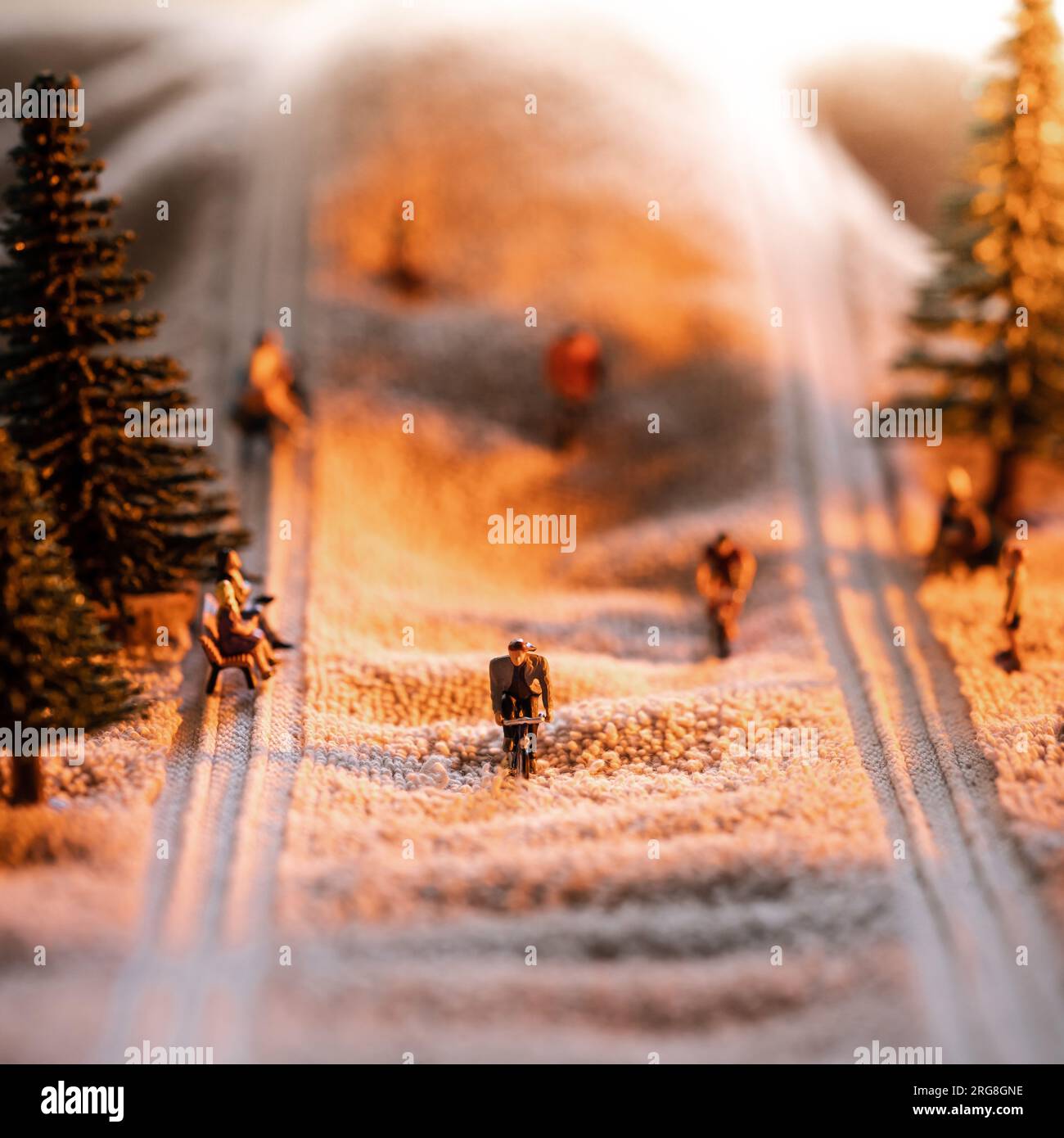 park and leisure concept Miniature cyclist is cycling down a slope ...