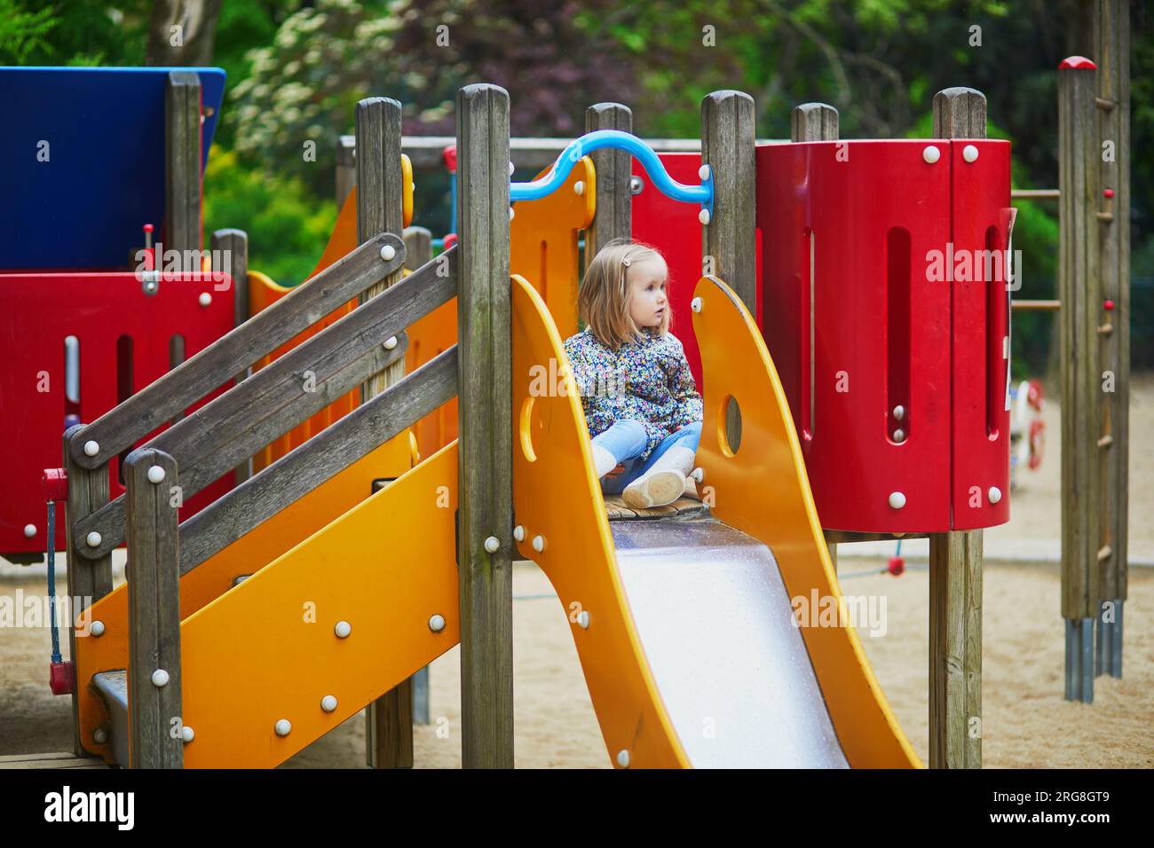 Happy 3 years old girl playing on a playground in Paris, France ...
