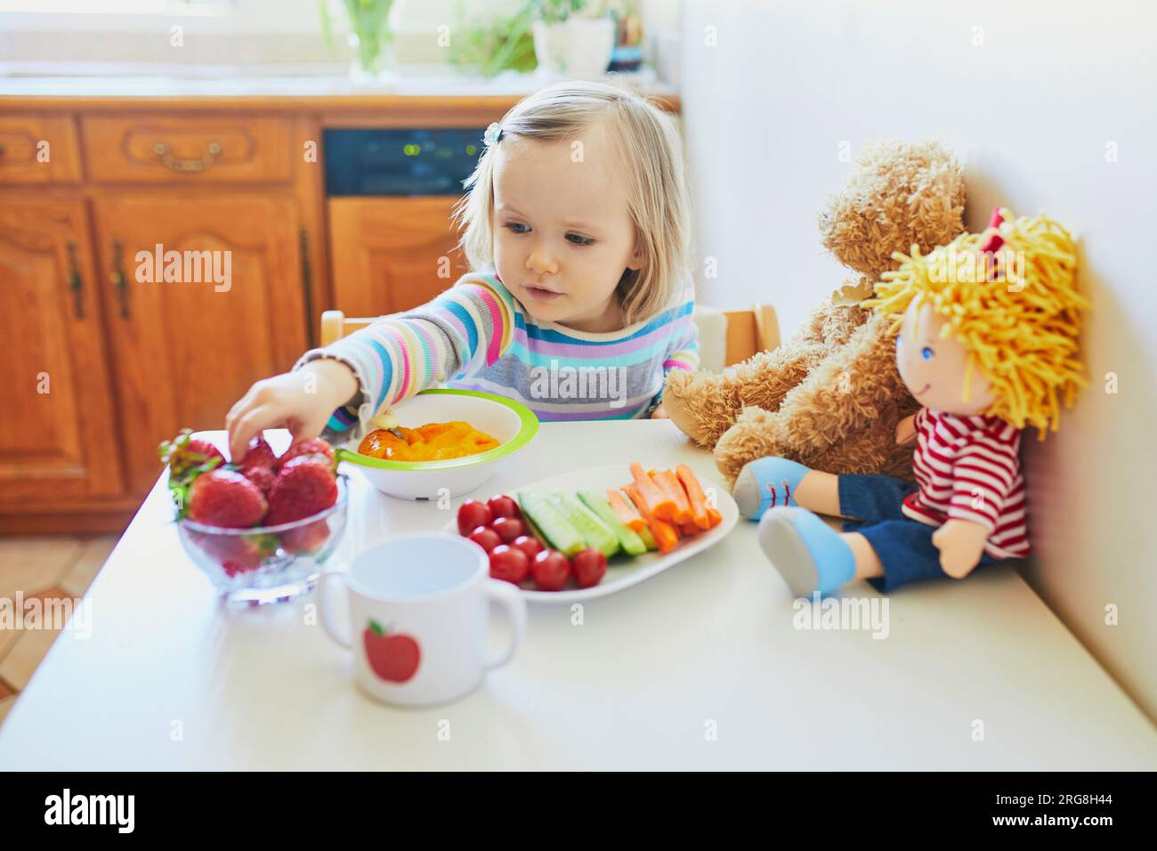 Children feeding teddy bear hi-res stock photography and images - Alamy