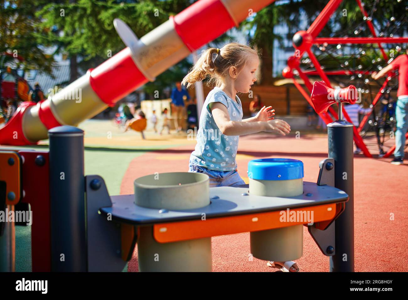 Adorable little girl on playground on a sunny day. Preschooler child playing outdoors. Outdoor ...