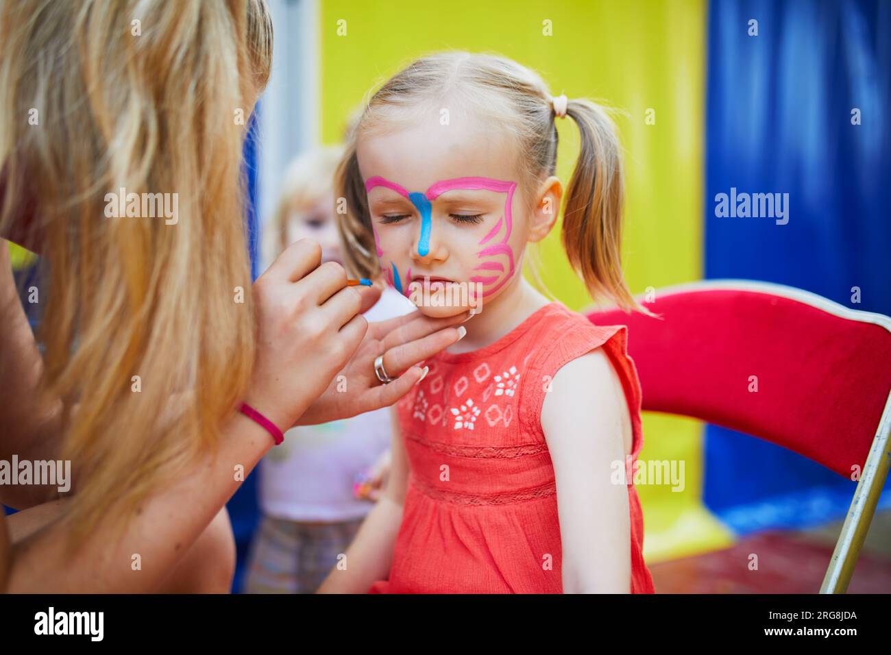 Children face painting. Artist painting little preschooler girl like ...